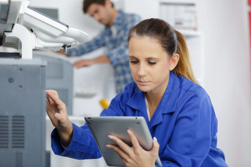 Female Technician Fixing Printer with Tablet Stock Photo - Image of ...