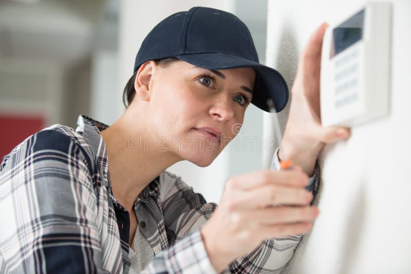 Female Technician Installing Security System on Wall Stock Photo ... Female Technician Installing Security System on Wall Stock Photo ...