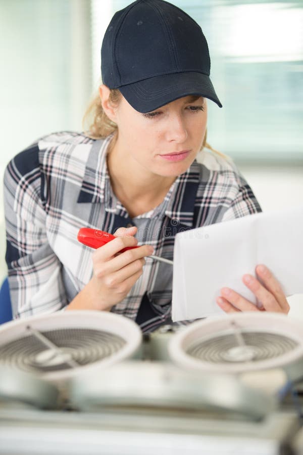 Female Technician Reading Instruction Manual Stock Photo - Image of ...