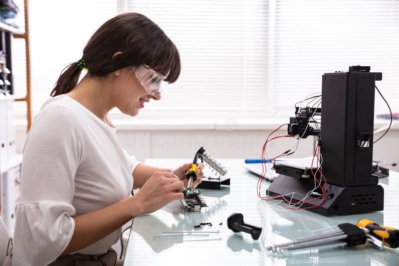 Female Technician Using Soldering Iron Stock Photo - Image of machine ...