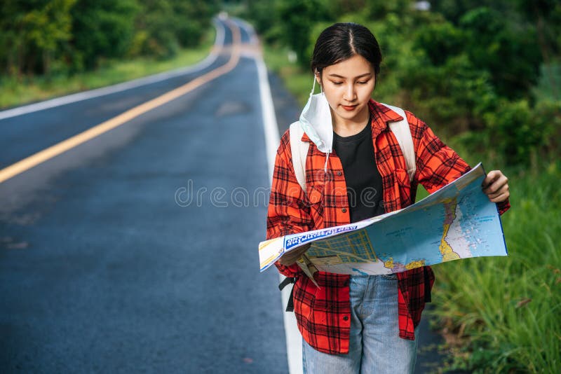 Female Tourists Stand and Look at the Map on the Road Stock Image ...