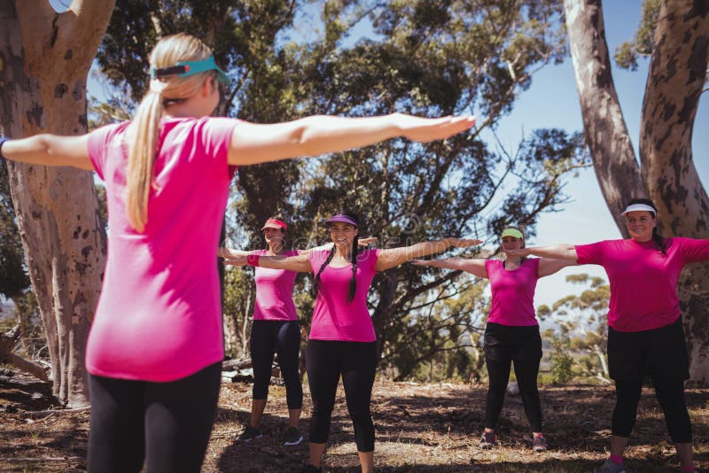 Female Trainer Instructing Women while Exercising in the Boot Camp ...