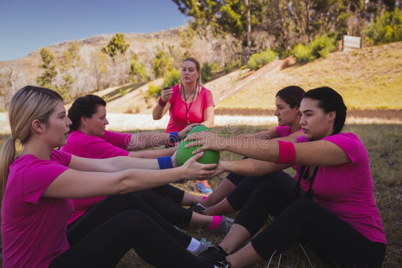 Female Trainer Instructing Women while Exercising in the Boot Camp ...
