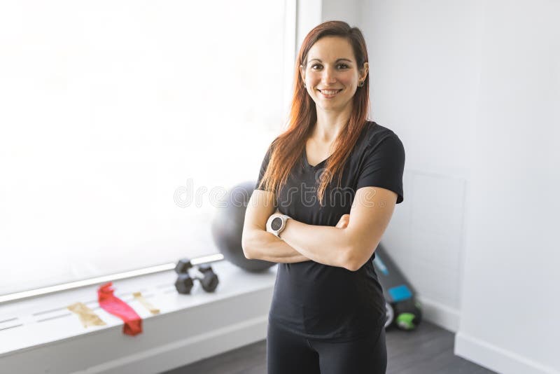 Female Trainer Standing with a Smile in the Training Gym Stock Image ...