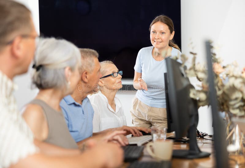 Female Tutor Teaching Group of Seniors in Computer Workshop Stock Image ... Female Tutor Teaching Group of Seniors in Computer Workshop Stock Image ...