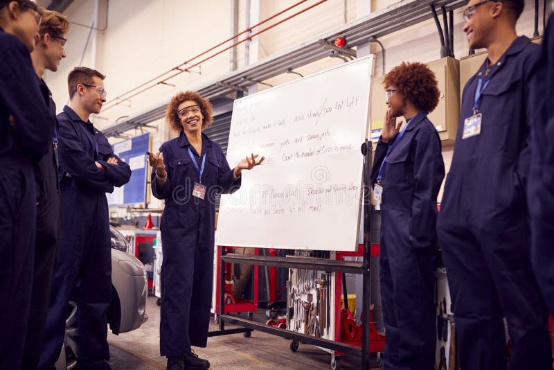 Female Tutor by Whiteboard with Students Teaching Auto Mechanic ...