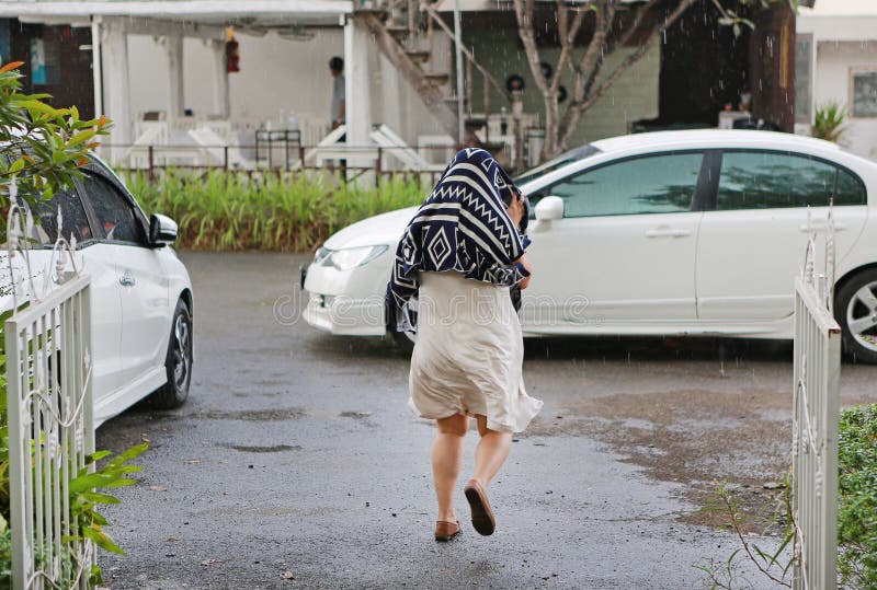 Female Under Rain Drops Cover Head with Shawl. Rear View Stock Photo ...