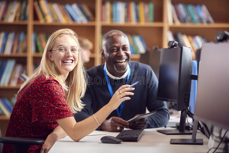 Female University or College Student Working at Computer in Library ...