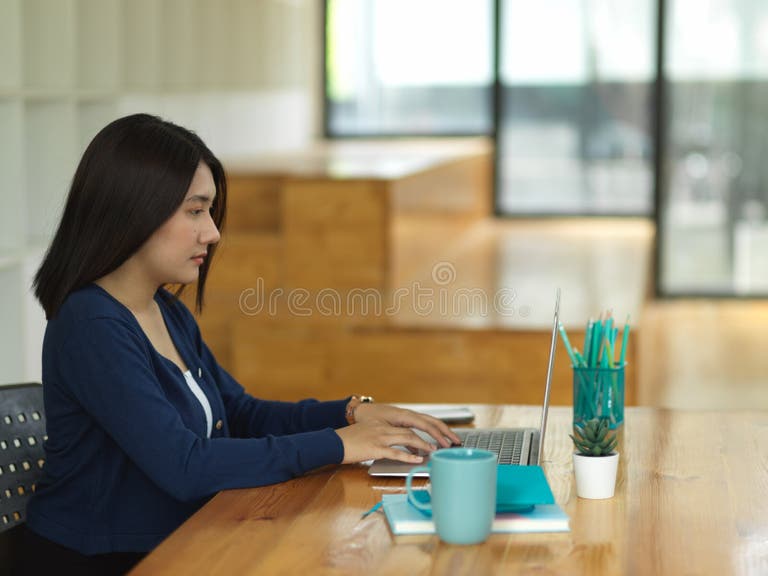 Female University Student Doing Assignment with Laptop and Stationery ...