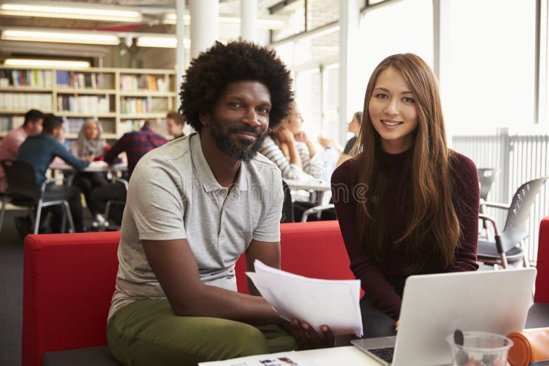 Female University Student Working in Library with Tutor Stock Photo ...