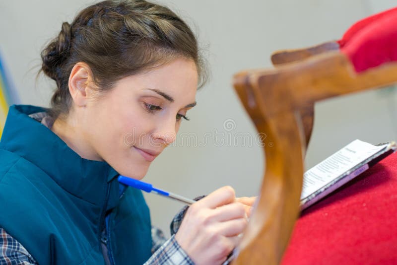 Female Upholstery Worker Writing Information Stock Photo - Image of ...