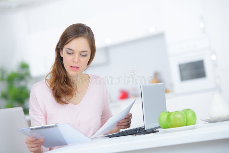 Female Using Computer and Laptop in Kitchen Stock Photo - Image of ...