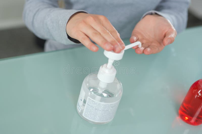Female Using Hand Press with Alcohol-based Sanitizer on Hands Stock ...