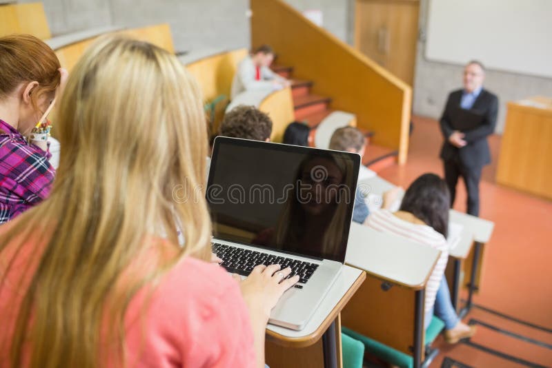 Female Using Laptop with Students and Teacher at Lecture Hall Stock ...