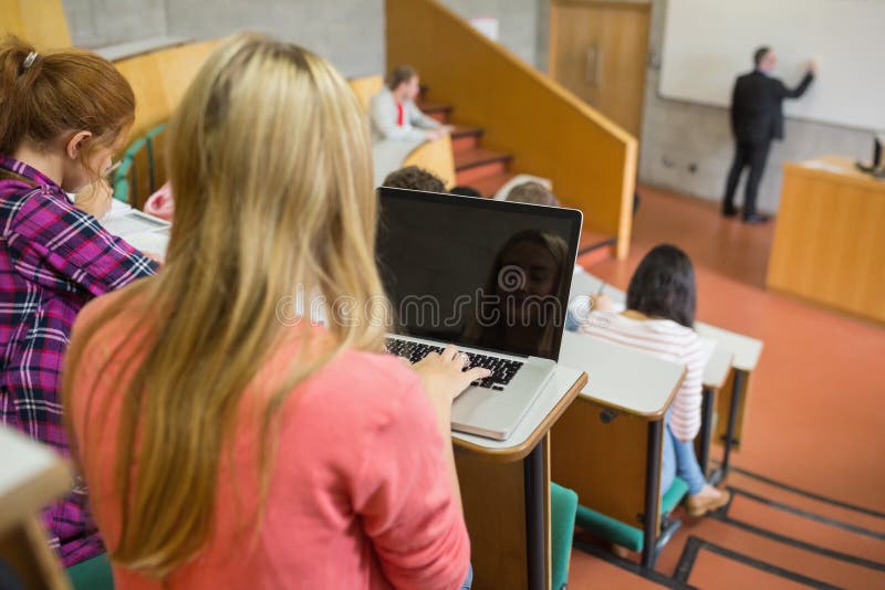 Female Using Laptop with Students and Teacher at Lecture Hall Stock ...