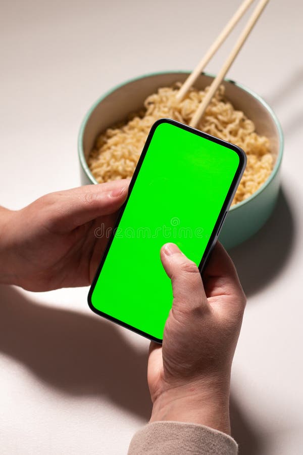 Female Using Smartphone while Eating Pasta at Home. Smartphone with ...