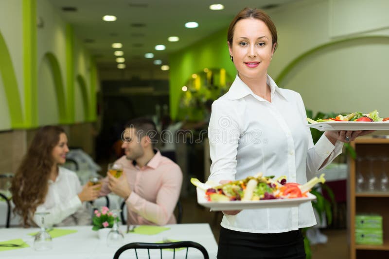 Female Waiter Serving Guests Table Stock Image - Image of person ...