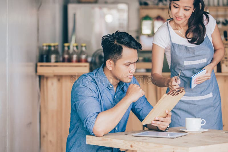 Female Waitress Explain about the Menu To Her Customer Stock Image ...