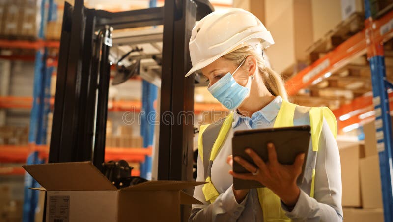 Female Warehouse Inventory Manager Wearing Face Mask for Safety, Using ...