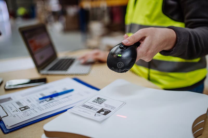 Female Warehouse Worker Holding Scanner, Scanning the Barcodes on ...