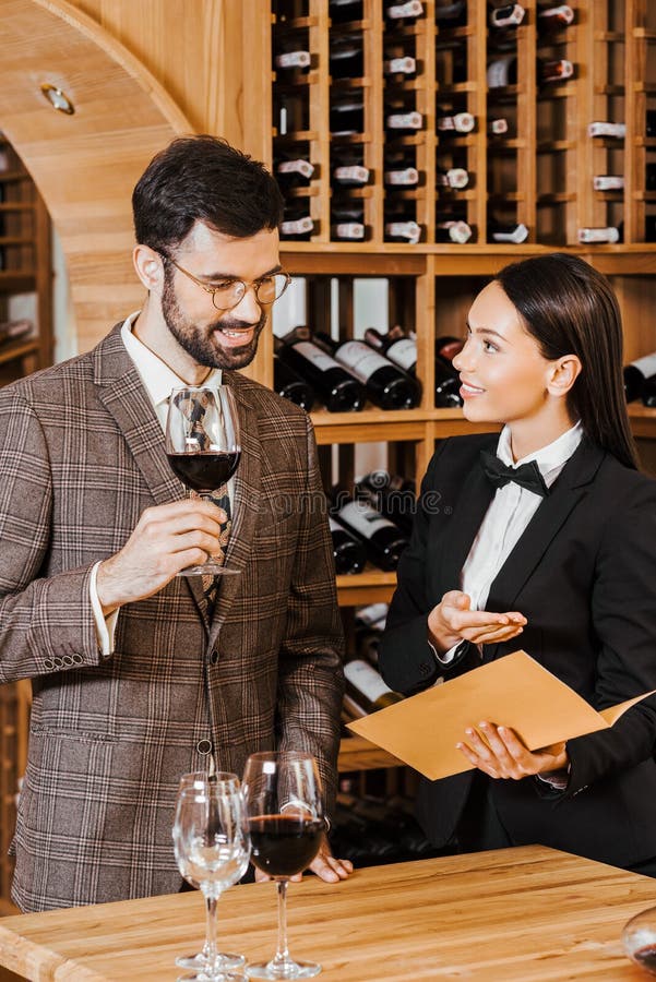 Female Wine Steward Showing Menu List To Client Stock Photo - Image of ...