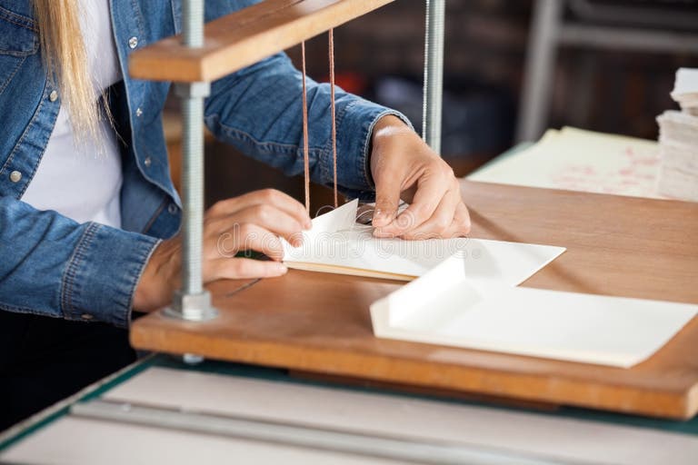 Female Worker Binding Papers at Workbench Stock Photo - Image of ...