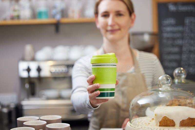 Female Worker in Cafe Serving Coffee in Sustainable Reusable Cup Stock ...
