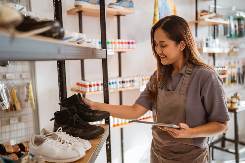 Female Worker Checking Product on Shelf Using Tablet Stock Image ...