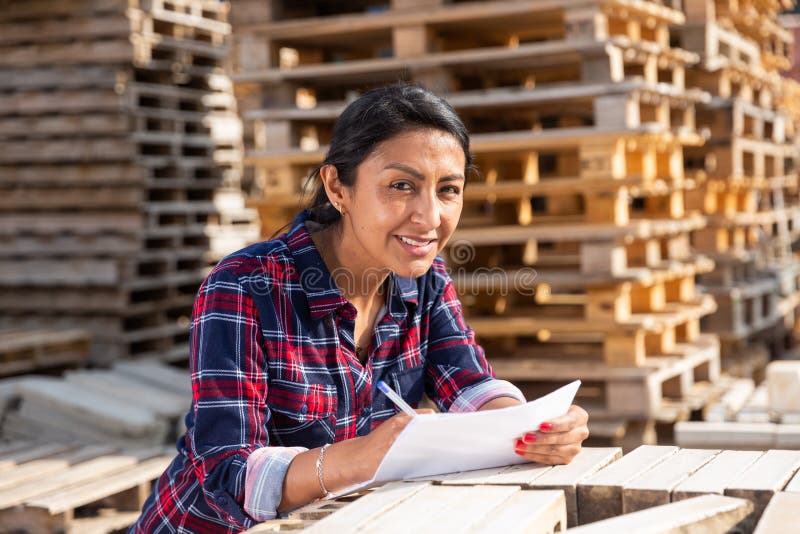 Female Worker Checking Quantity of Red Bricks in Warehouse Stock Photo ...