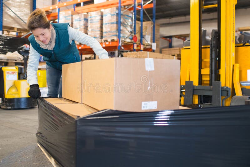 Female Worker Checking Shrink Wrap on Forklift Load Stock Photo - Image ...