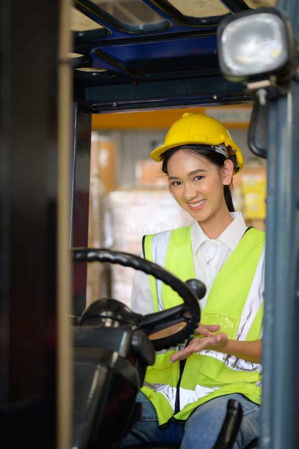 Female Worker Driving a Forklift Moving Goods Stock Photo - Image of ...