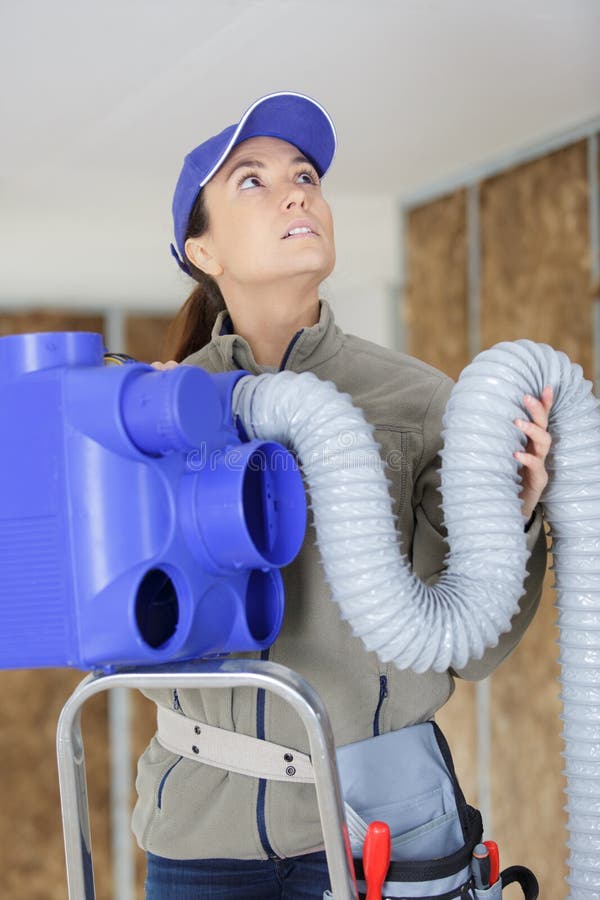 Female Worker Fitting Ventilation System Stock Image - Image of piping ...