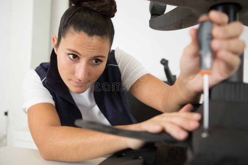 Female worker fixing chair stock photo. Image of fittings - 280480180
