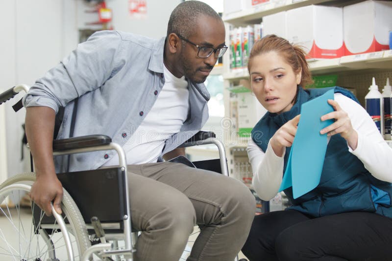 Female Worker and Handicaped Man in Hardware-store Stock Photo - Image ...