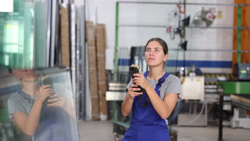 Female Worker Moves Window Panes Using a Lifting Mechanism in an ...