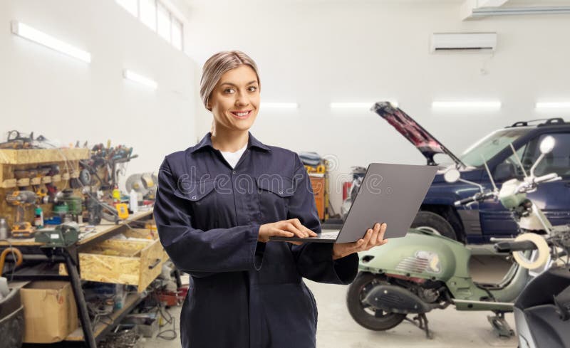 Female Worker in a Navy Blue Overall Uniform with a Laptop Computer ...