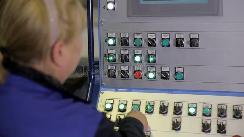 Female Worker Operating Industrial Control Panel, Display at a Modern ...