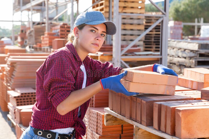 Female Worker with Bricks in Warehouse Stock Photo - Image of woman ...