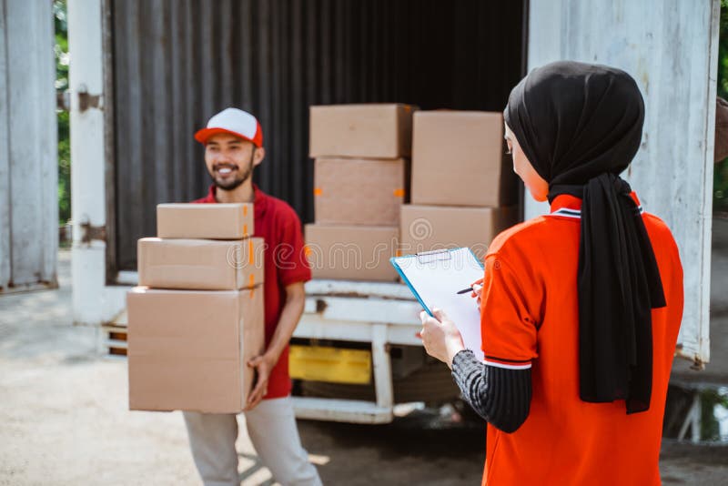 Female Worker with Notes Checking the Package by Delivery Man Stock ...