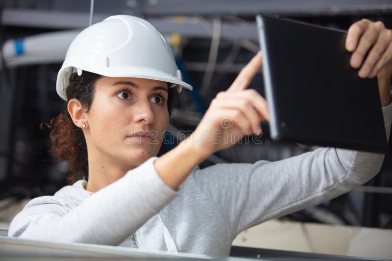 Female Worker Taking Photograph with Tablet in Roofspace Stock Photo ...