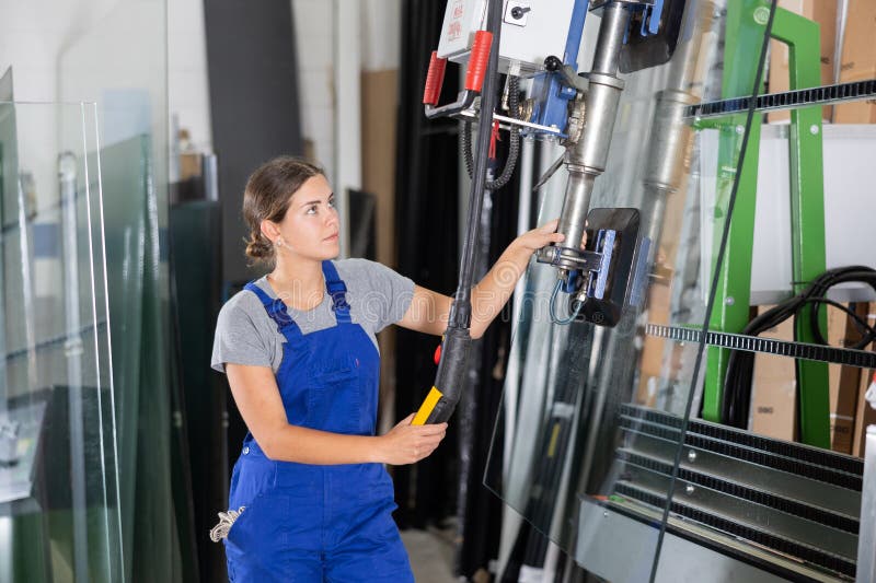 Female Worker Using Control Panel and Lifting Mechanism Controls ...