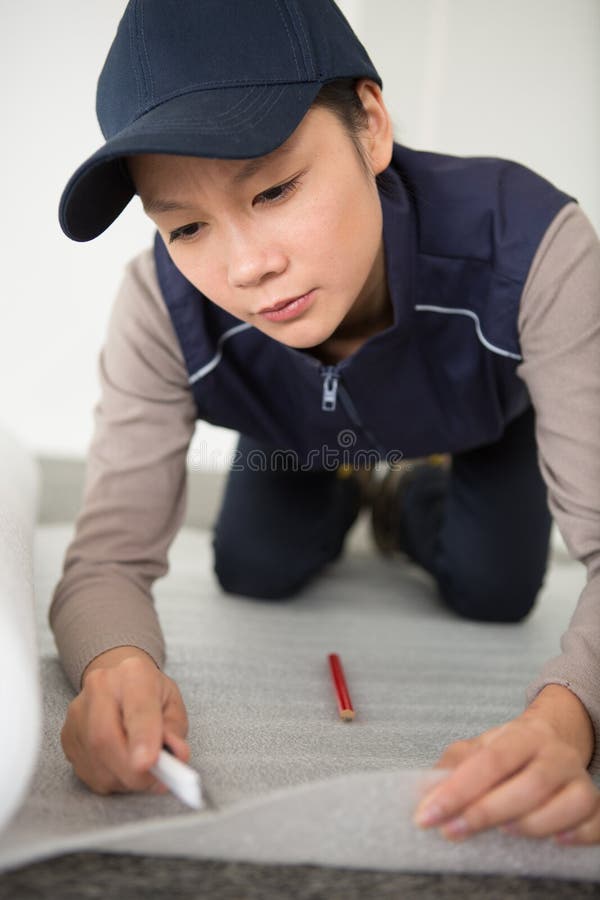 Female Worker Using Cutter Knife while Doing Flooring Stock Photo ...