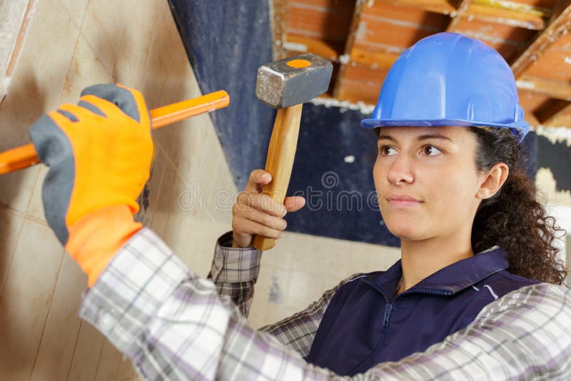 Female worker using hammer stock image. Image of engineer - 265994259
