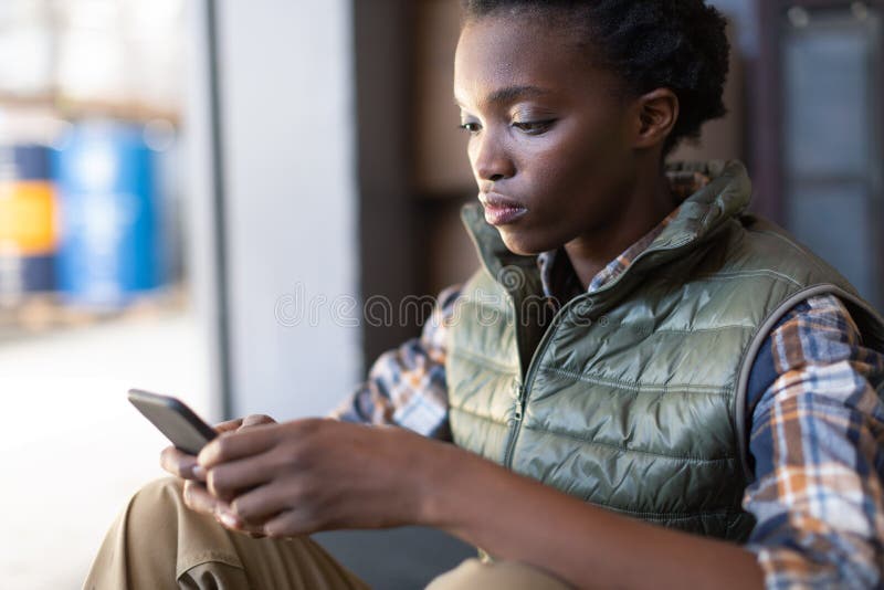 Female Worker Using Mobile Phone in Warehouse Stock Photo - Image of ...