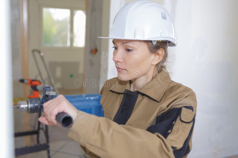 Female Worker Using Power Drill Stock Image - Image of uniform, hand ...
