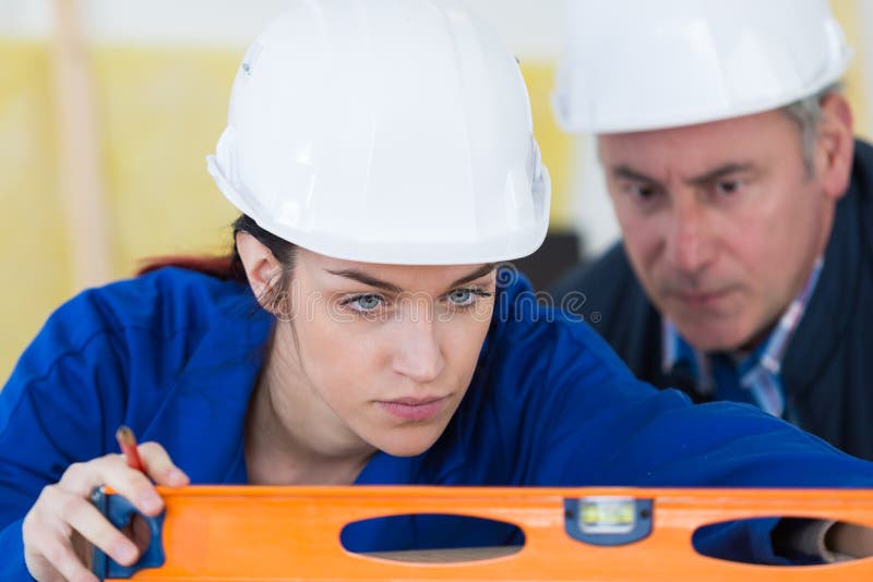 Female Worker Using Spirit Level Stock Image - Image of girl, eyes ...