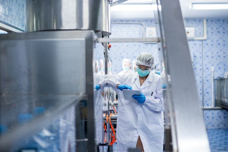 Female Worker Using Tablet Checking Quality Drinking Water before ...