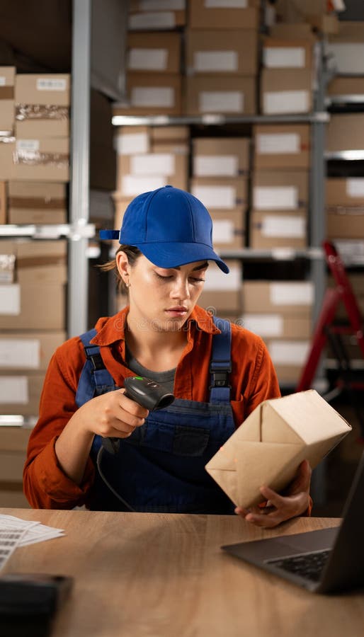 Female Worker in Warehouse Using Bar Code Scanner To Scanning Box ...