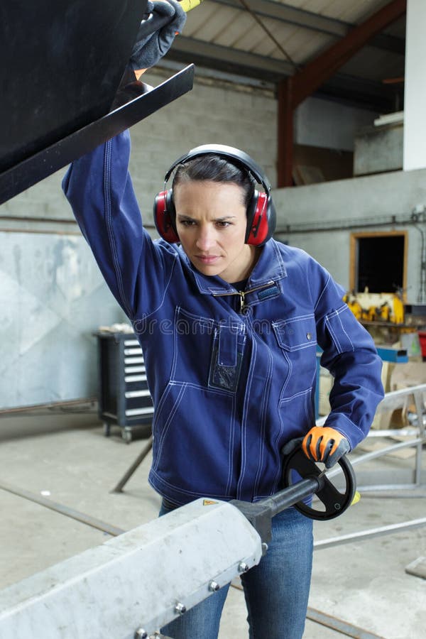 Female Worker Working on Machinery at Industry Stock Image - Image of ...