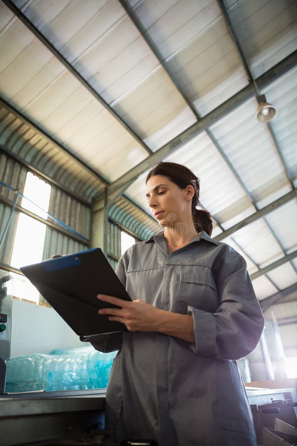Female Worker Writing on Clipboard in Olive Factory Stock Image - Image ...